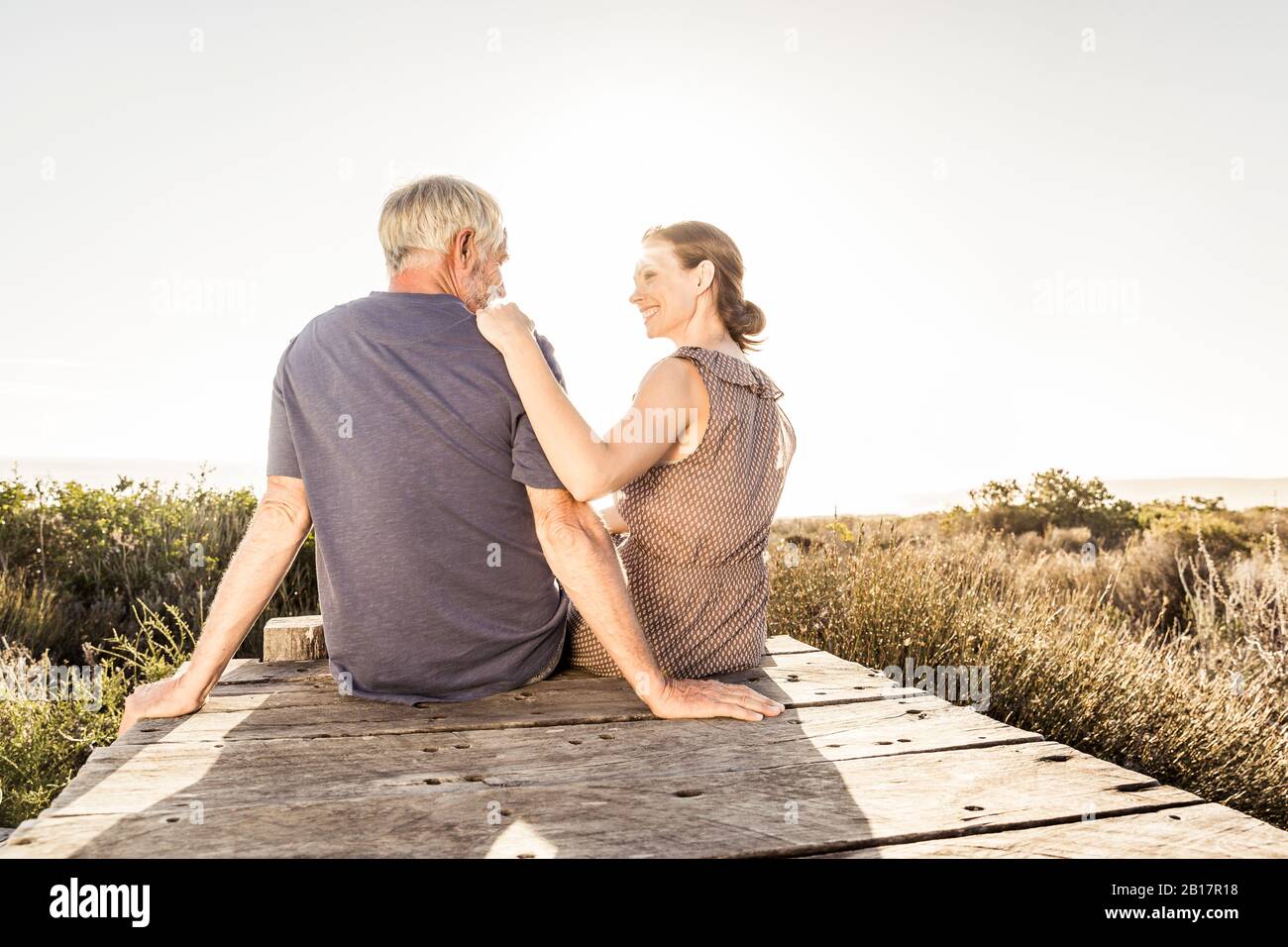 Rear view of couple sitting hi-res stock photography and images - Alamy