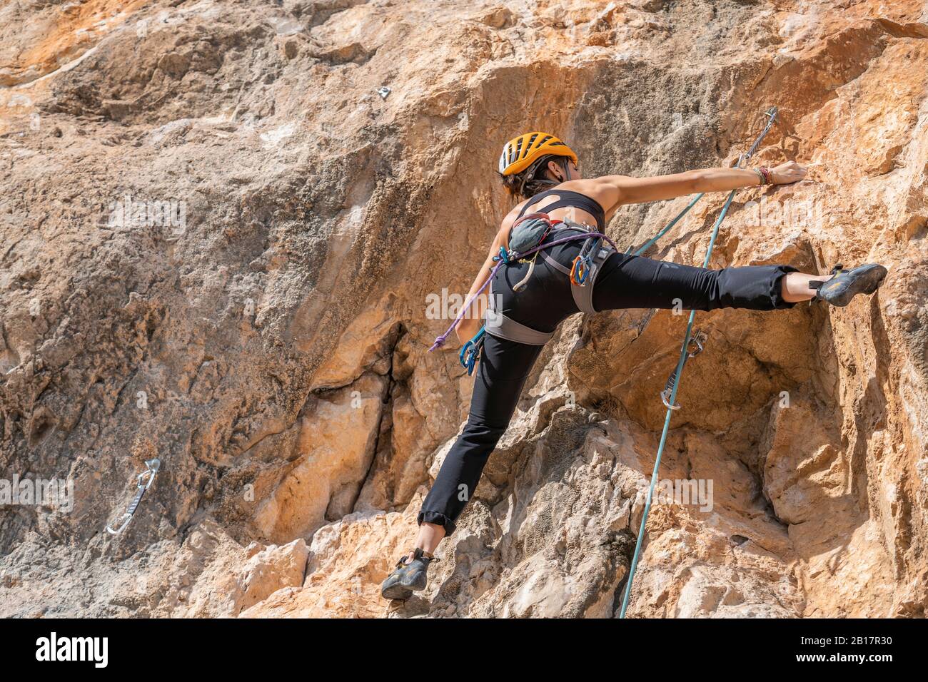 Woman climbing at rock face Stock Photo - Alamy