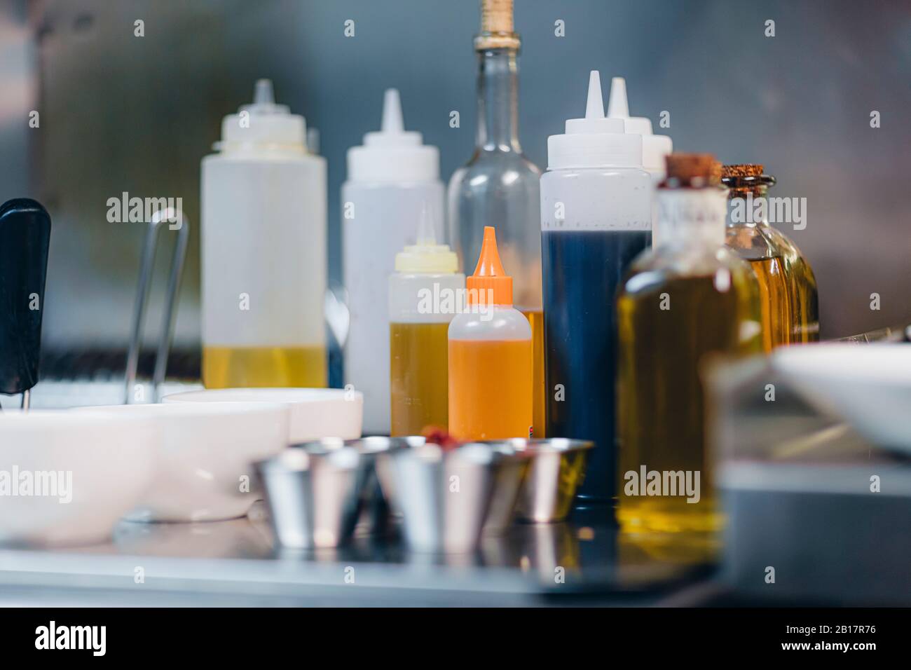 Detail of spicy oil bottles in restaurant kitchen Stock Photo - Alamy