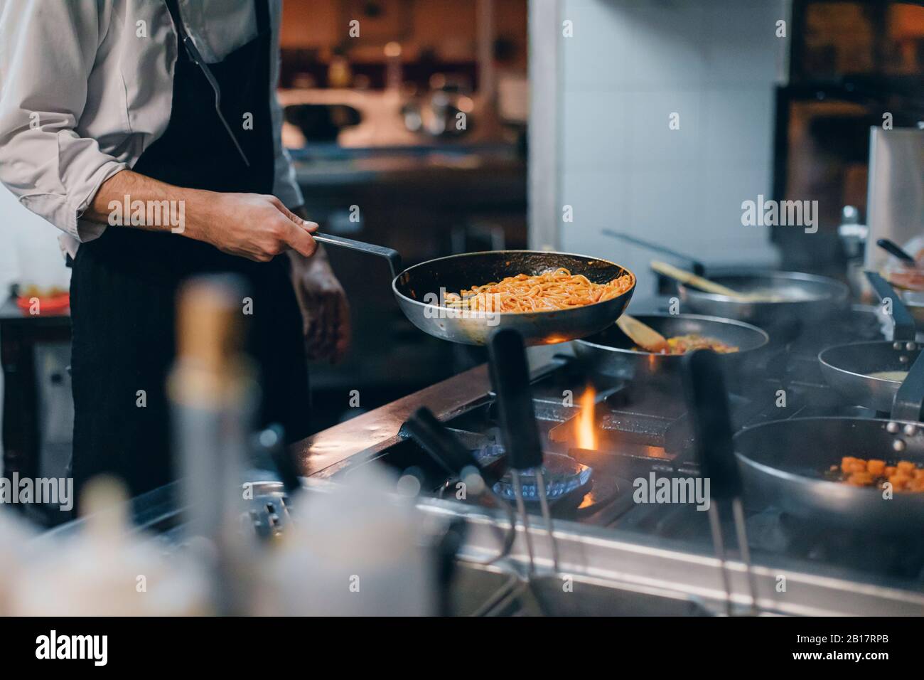 Chef cooking pasta in Italian restaurant kitchen Stock Photo - Alamy