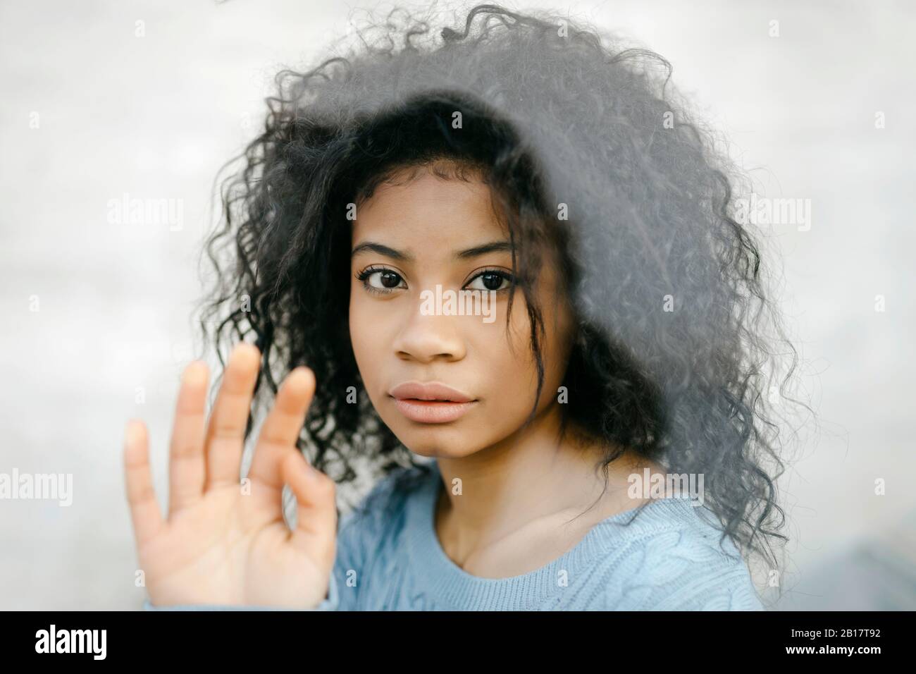 Portrait of a beautiful young woman behind glass pane Stock Photo - Alamy