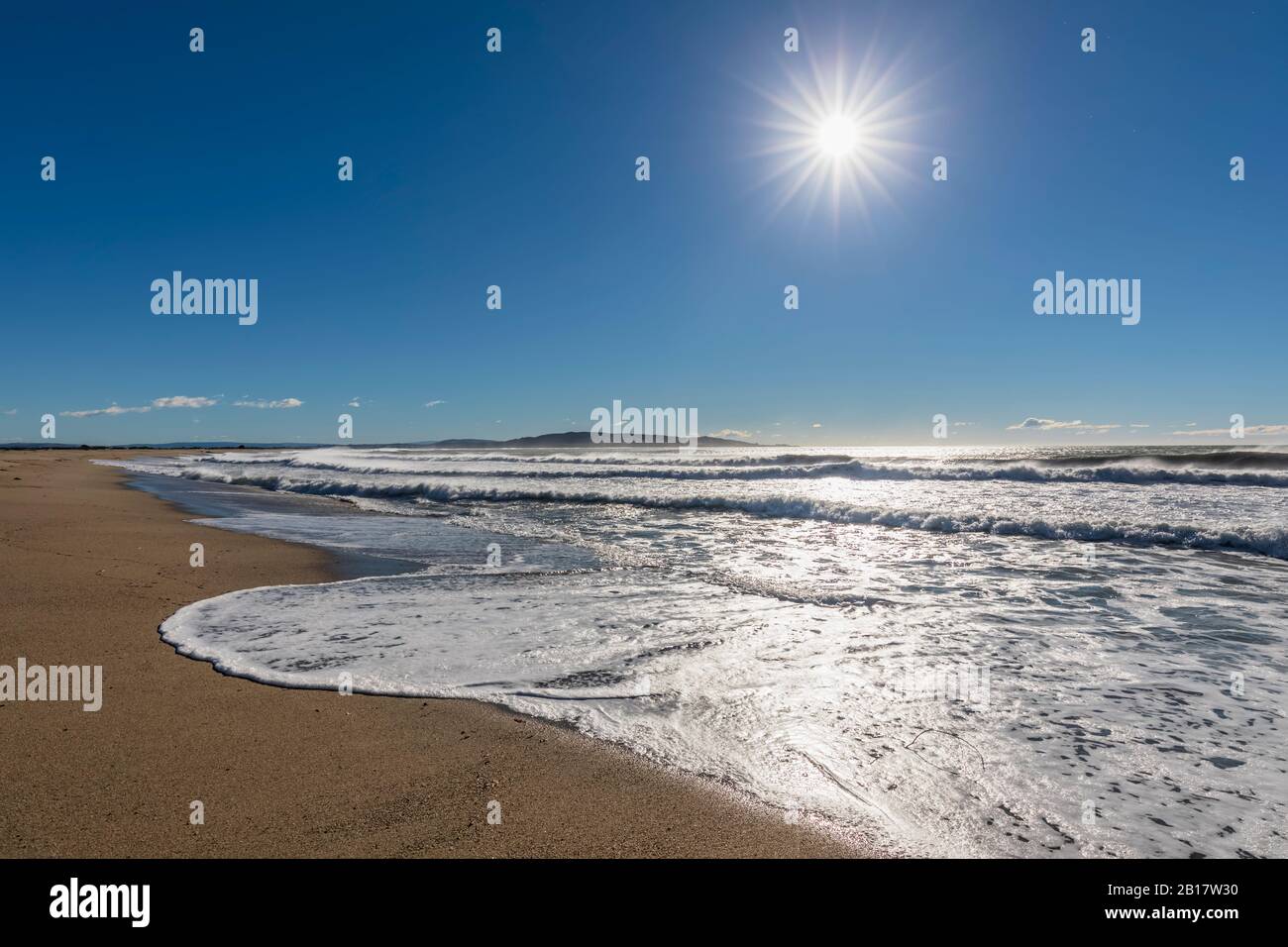 New Zealand, Kaka Point, Sun shining over sandy coastal beach Stock ...