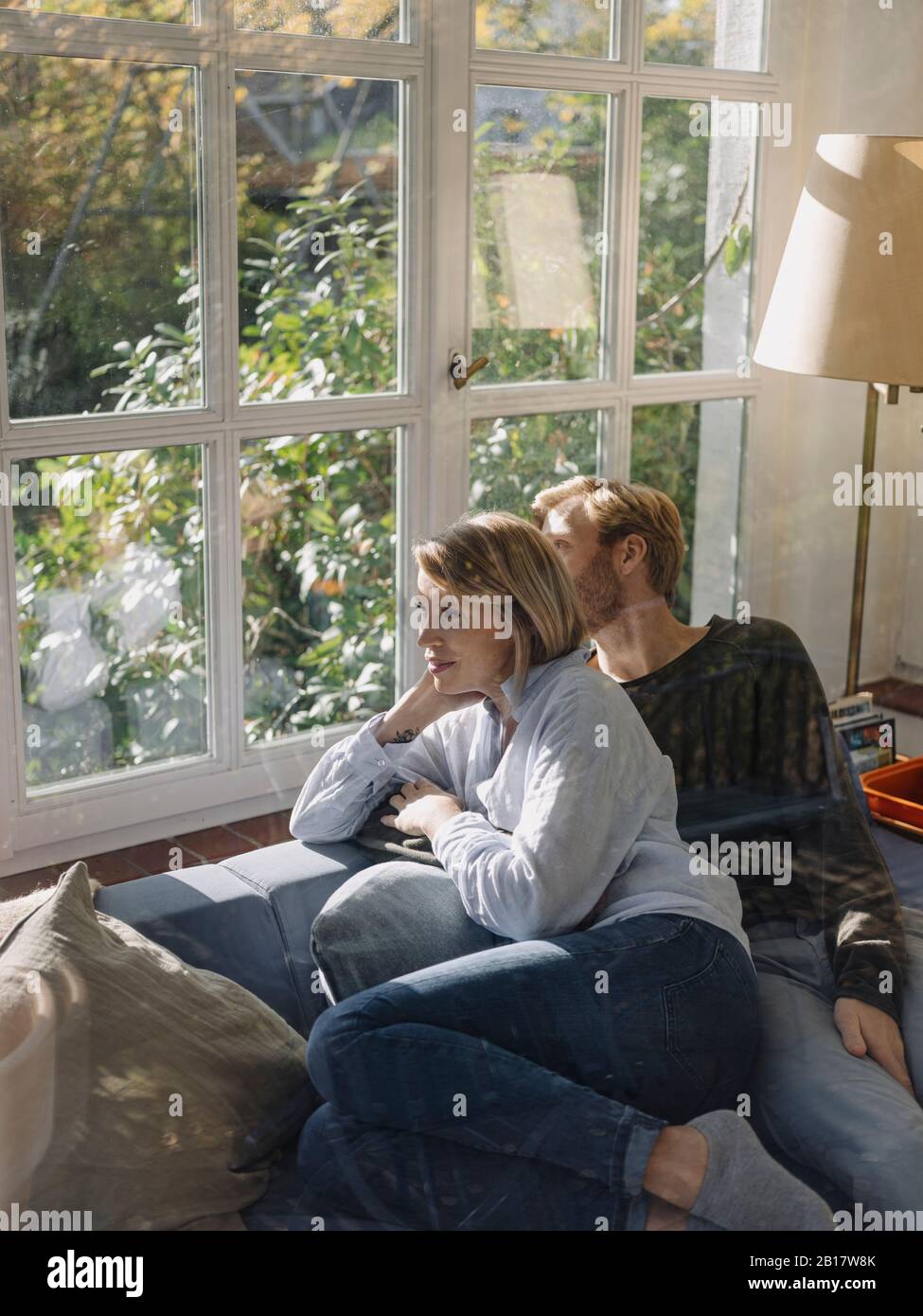 Man and woman looking out of windows hi-res stock photography and ...