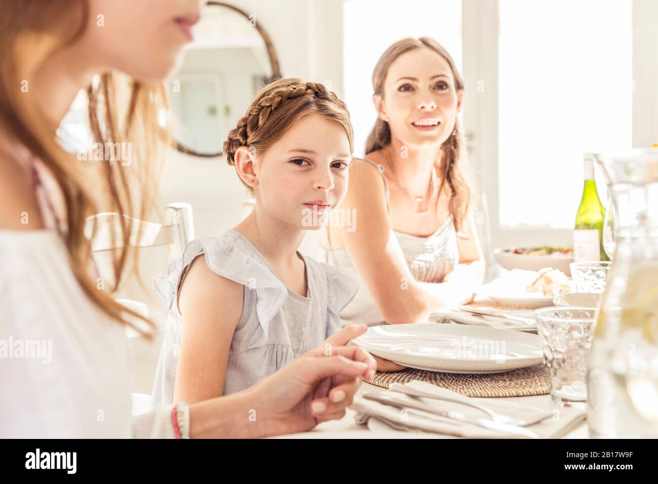 Girl and two women having lunch together Stock Photo - Alamy