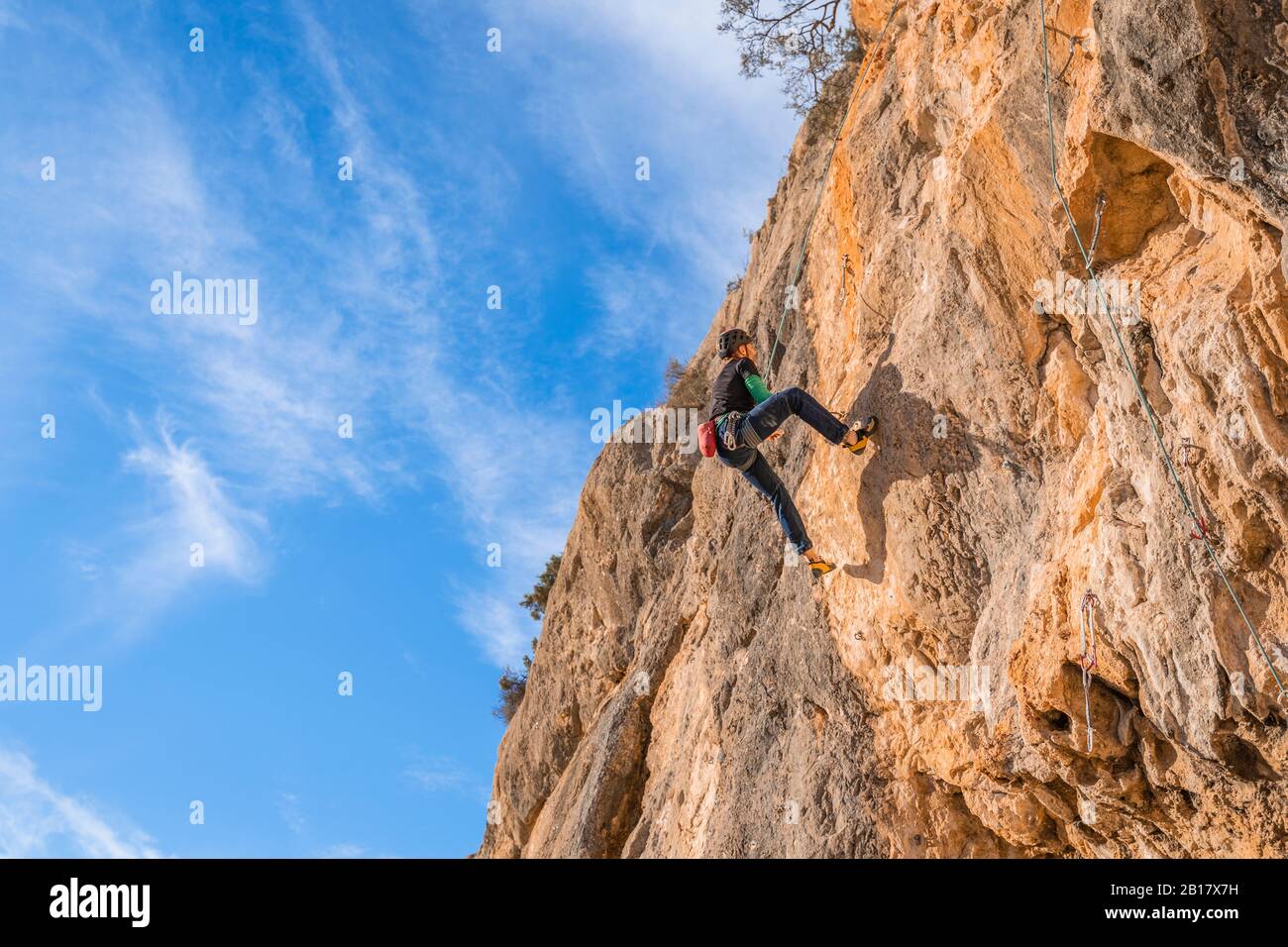 Man climbing at rock face Stock Photo - Alamy