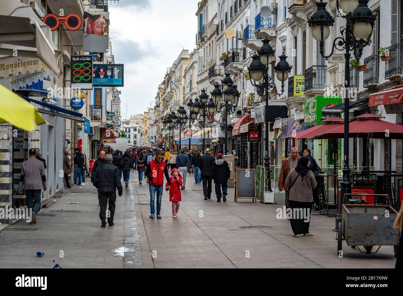 Tunis, Tunisia - People walking along a pedestrian shopping street ...