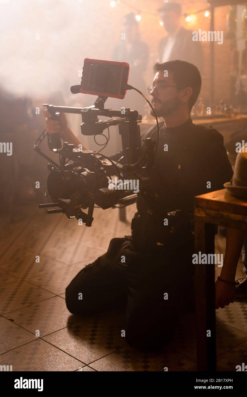 Cameraman at work on movie set Stock Photo - Alamy