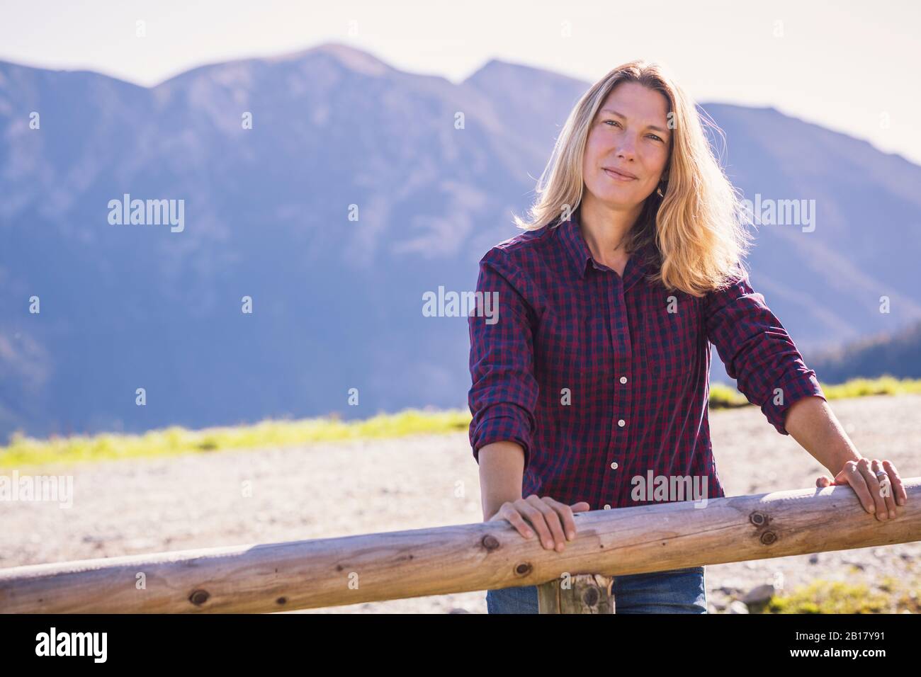 Portrait of woman in front of mountains Stock Photo - Alamy