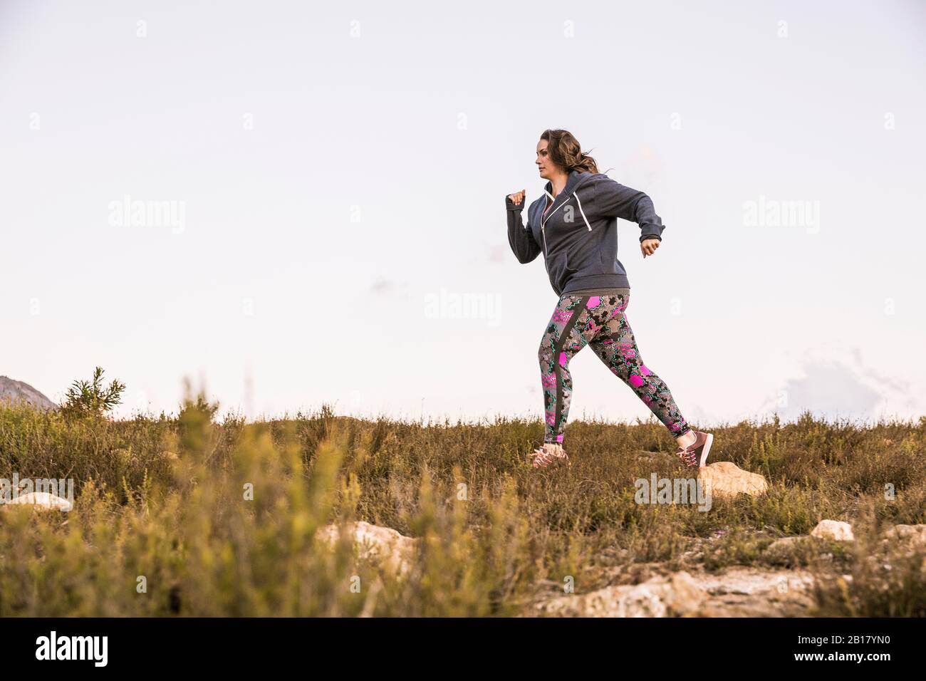 Plus-Size-Model jogging in the countryside Stock Photo - Alamy