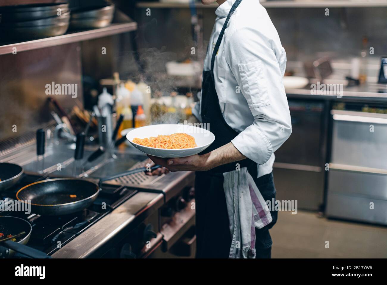Chef cooking pasta in Italian restaurant kitchen Stock Photo - Alamy