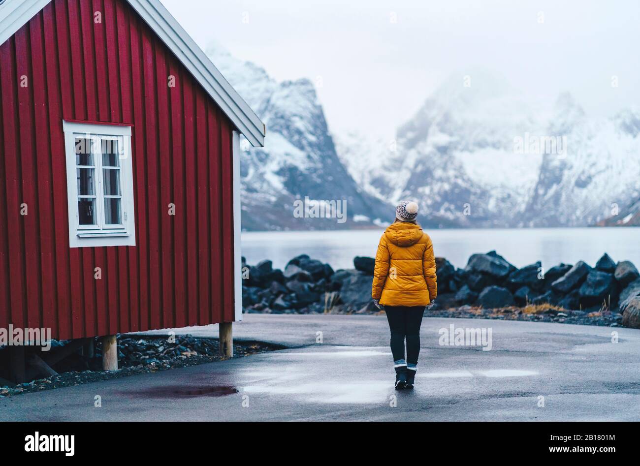 Tourist exploring the fishing village Hamnoy, Lofoten, Norway Stock ...