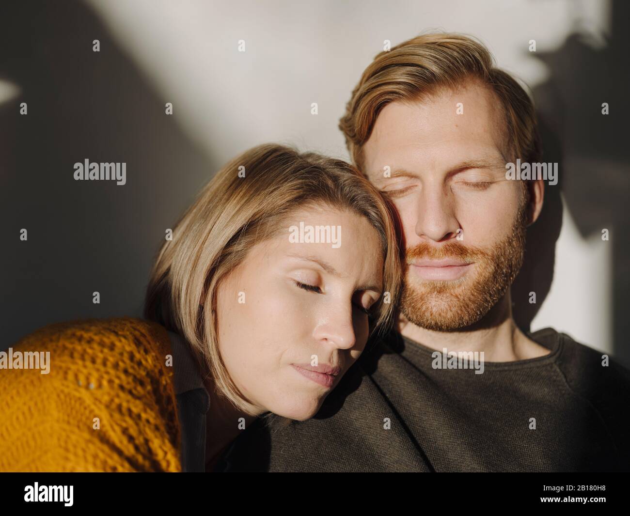 Portrait of relaxed couple in sunlight Stock Photo - Alamy