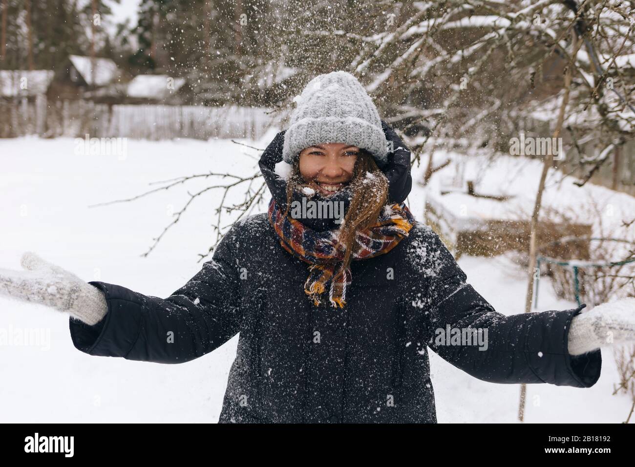 Portrait of woman enjoying snowfall Stock Photo - Alamy