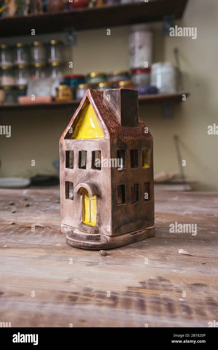 Tiny ceramic house on workbench in a pottery Stock Photo - Alamy