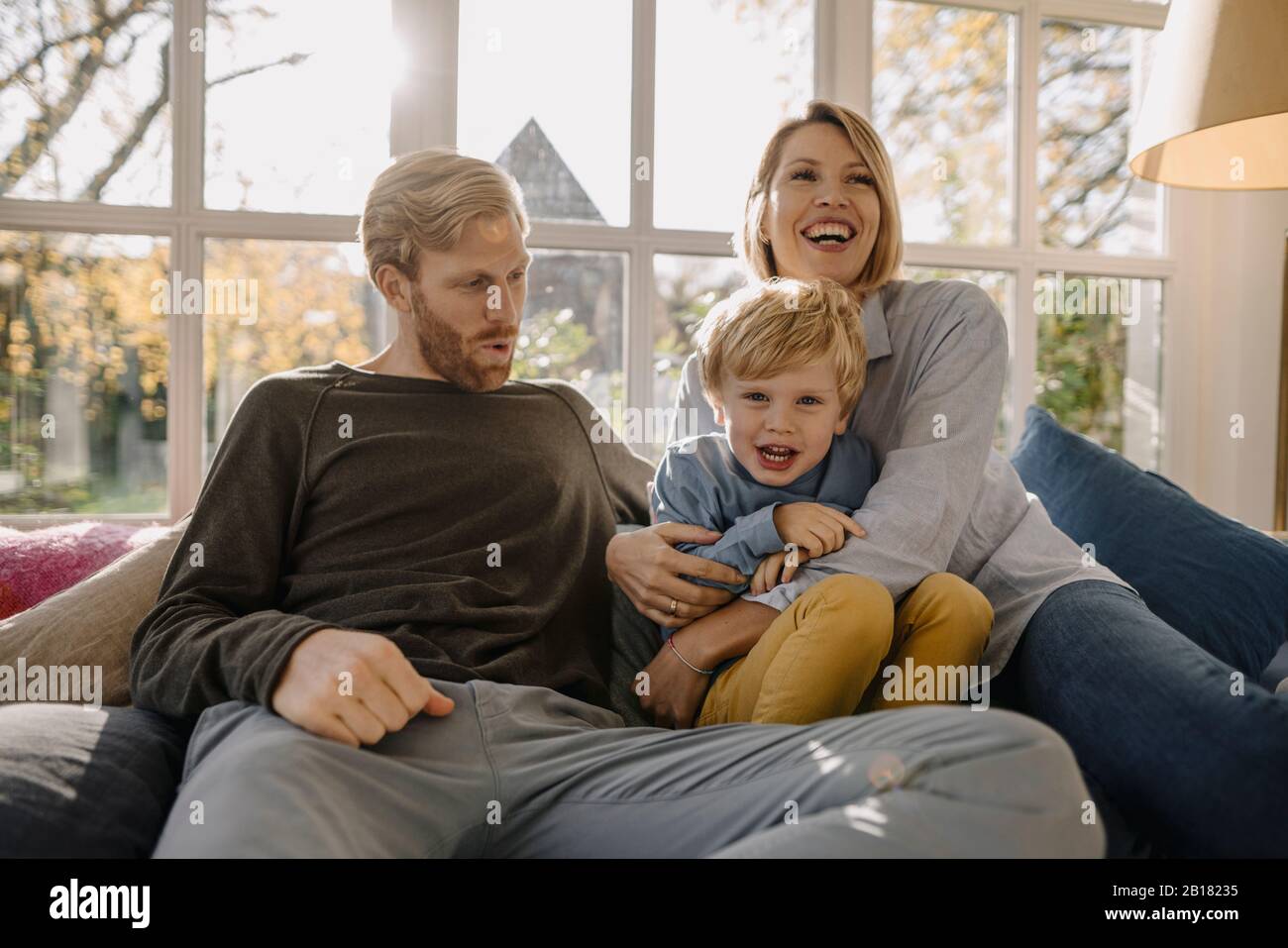 Happy family in sunroom at home Stock Photo - Alamy