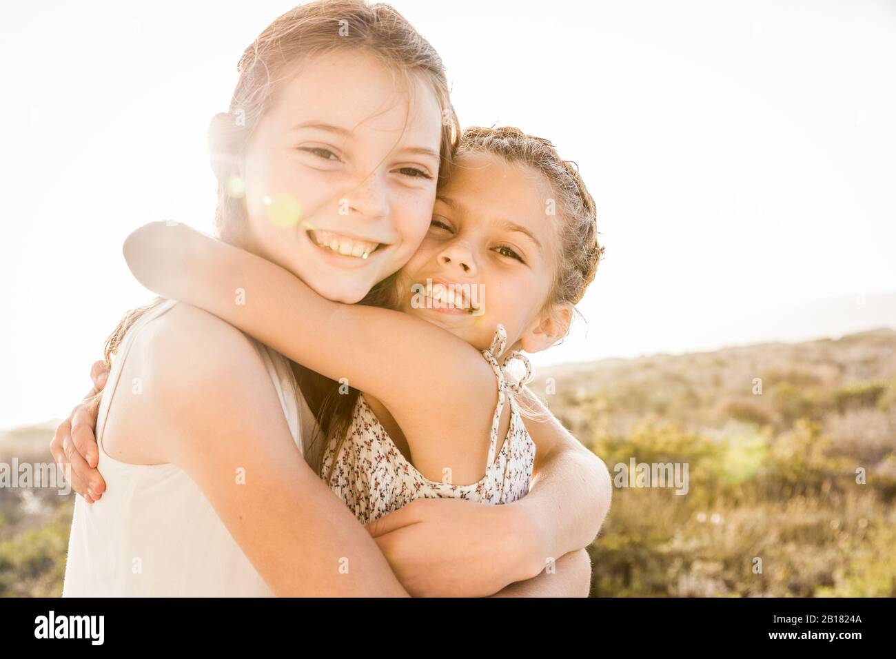 Two happy girls embracing hi-res stock photography and images - Alamy