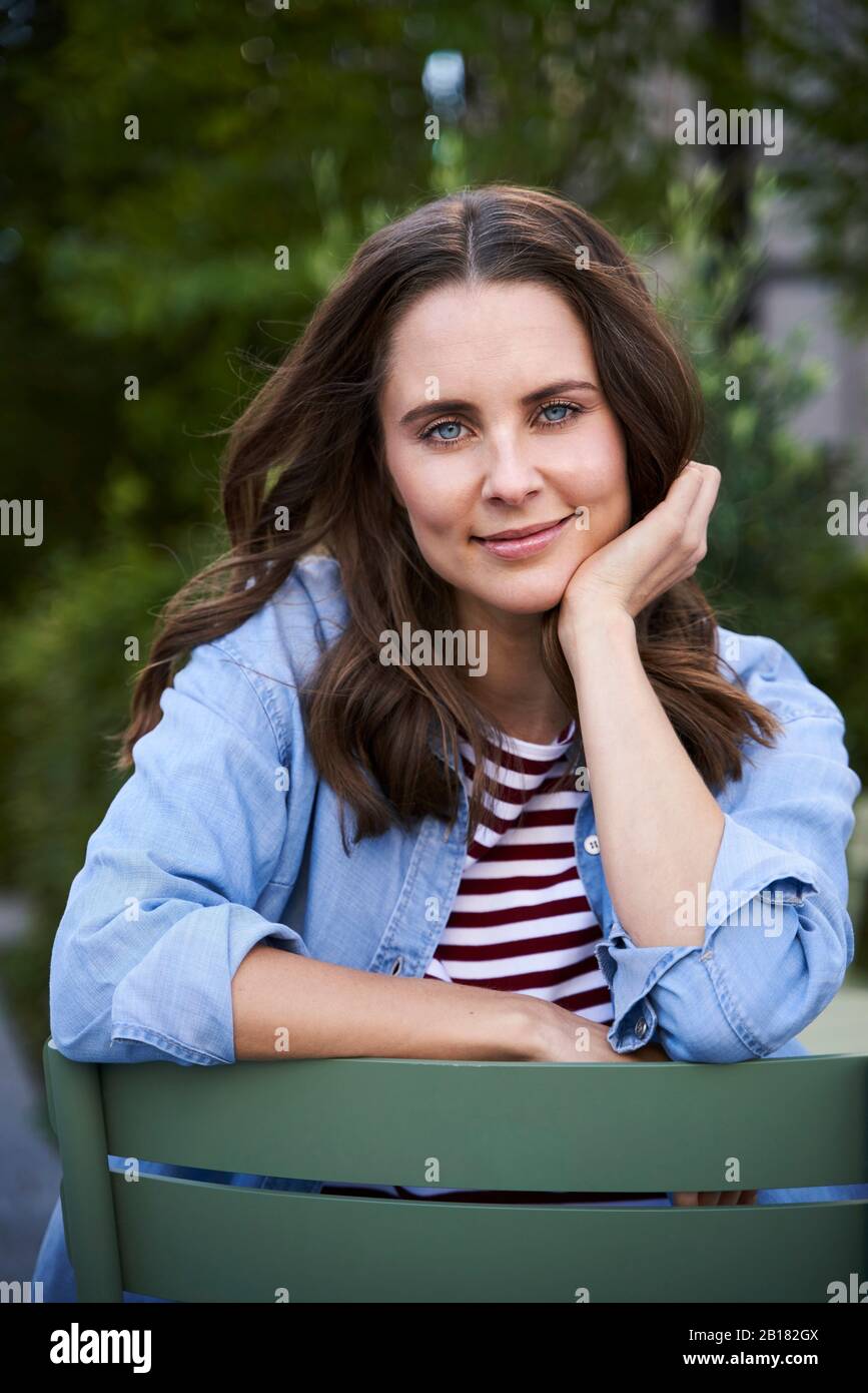 Portrait smiling woman sitting garden chair hi-res stock photography ...
