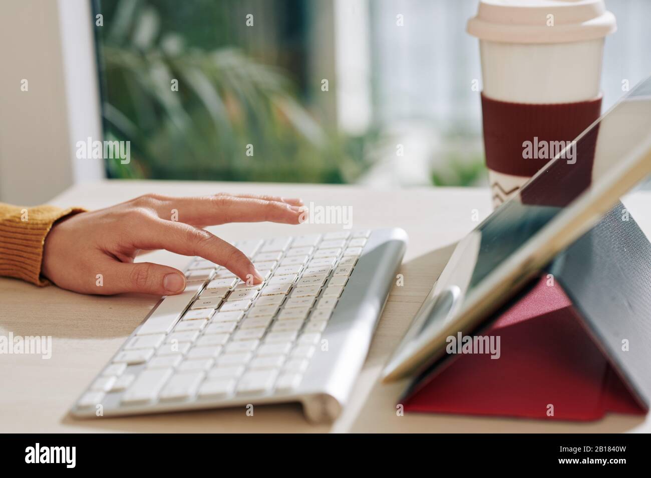 Close-up image of businesswoman working at her office desk and pushing ...