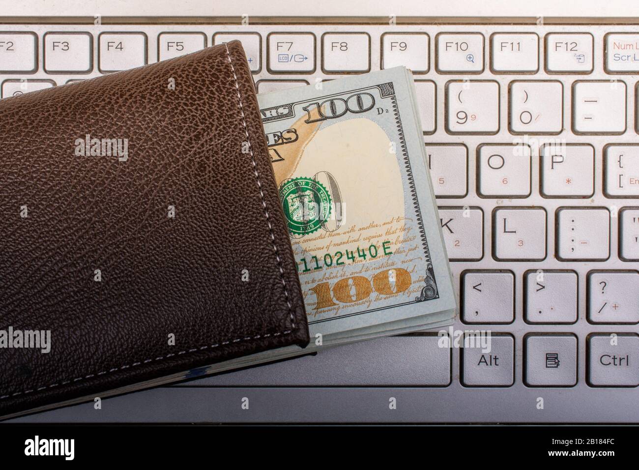 100 dollar bills on keyboard hi-res stock photography and images - Alamy