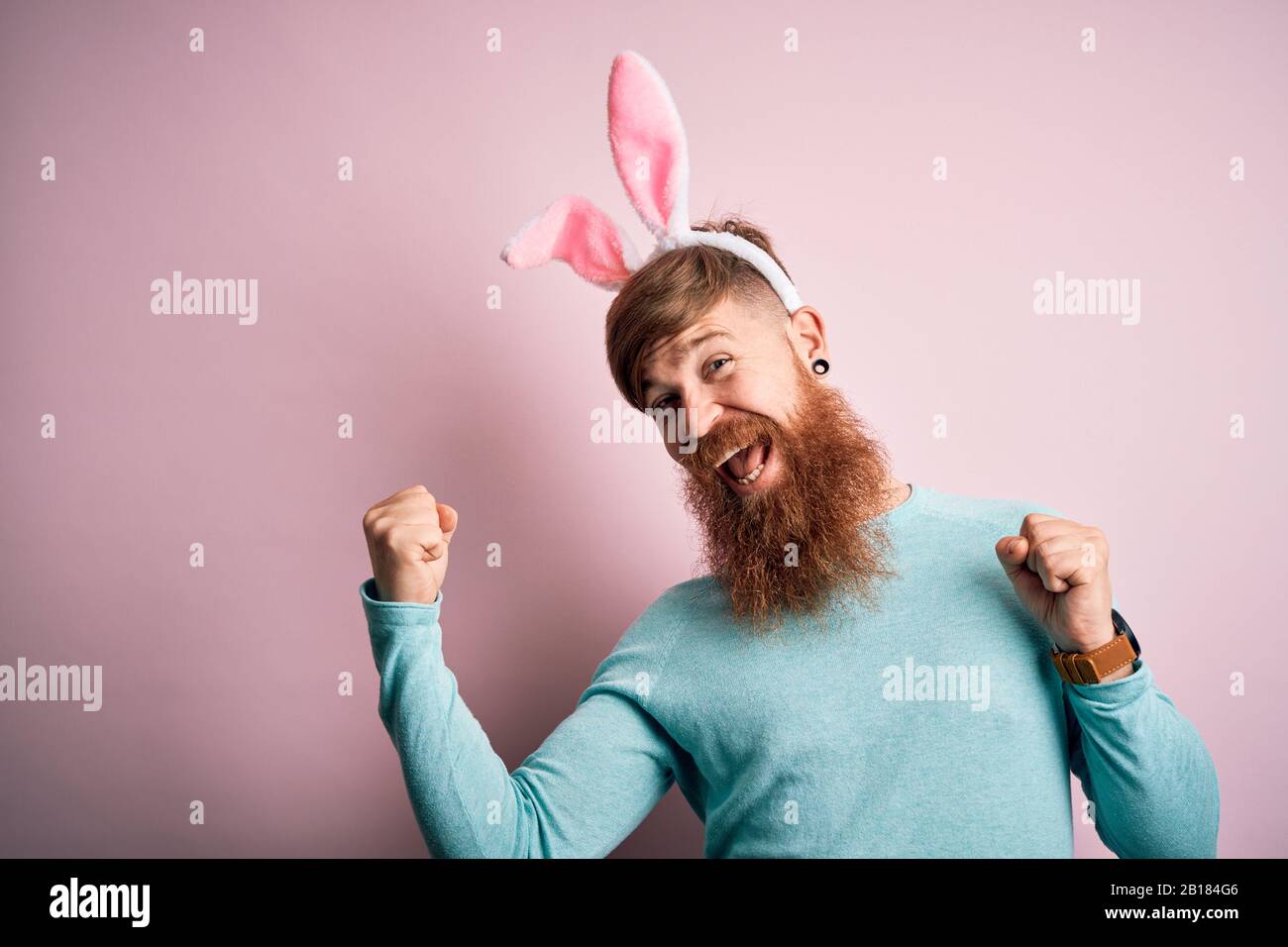 Hipster Irish man with beard wearing easter rabbit ears over isolated ...