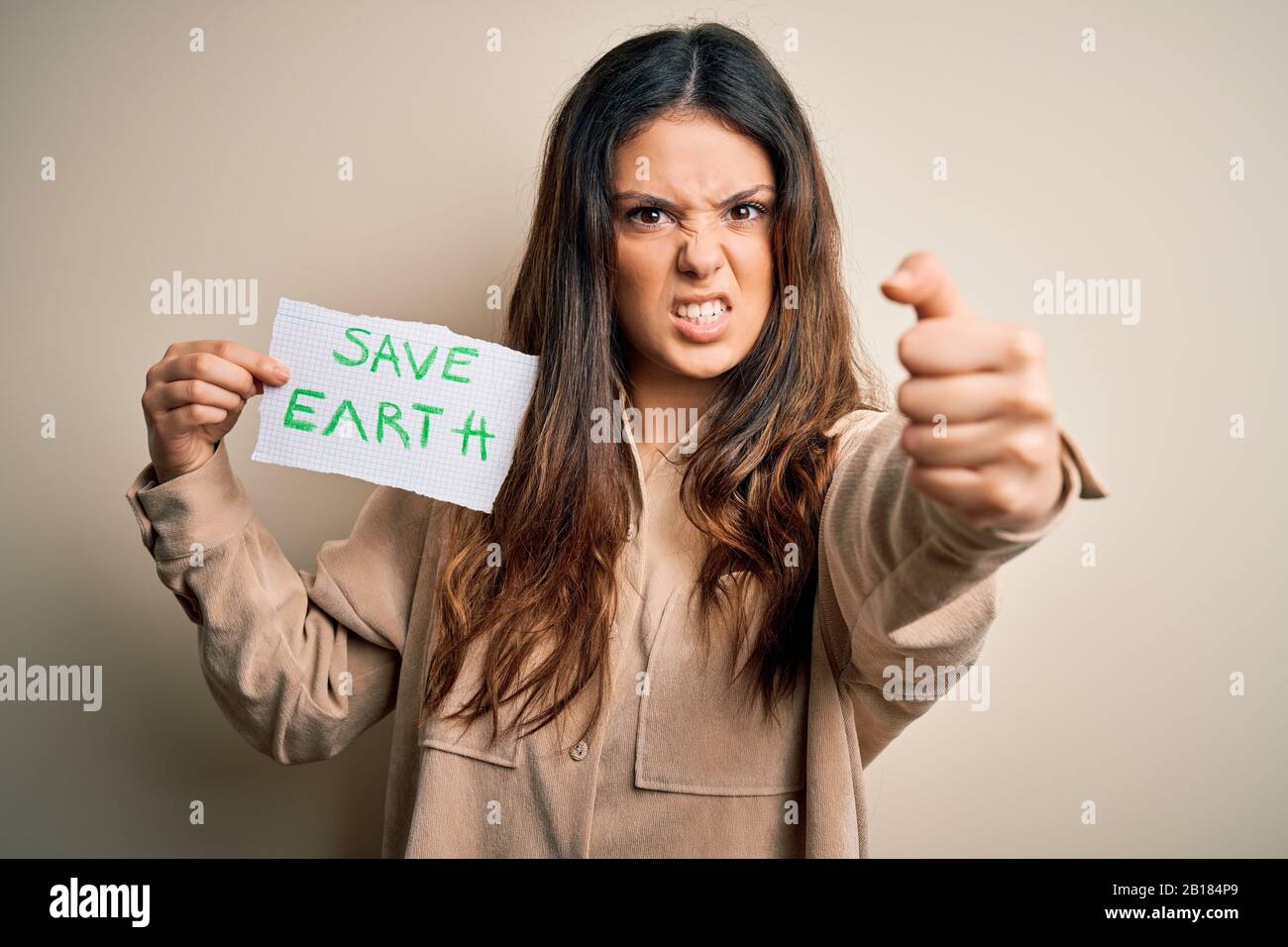 Young beautiful woman holding paper asking for save earth and ...
