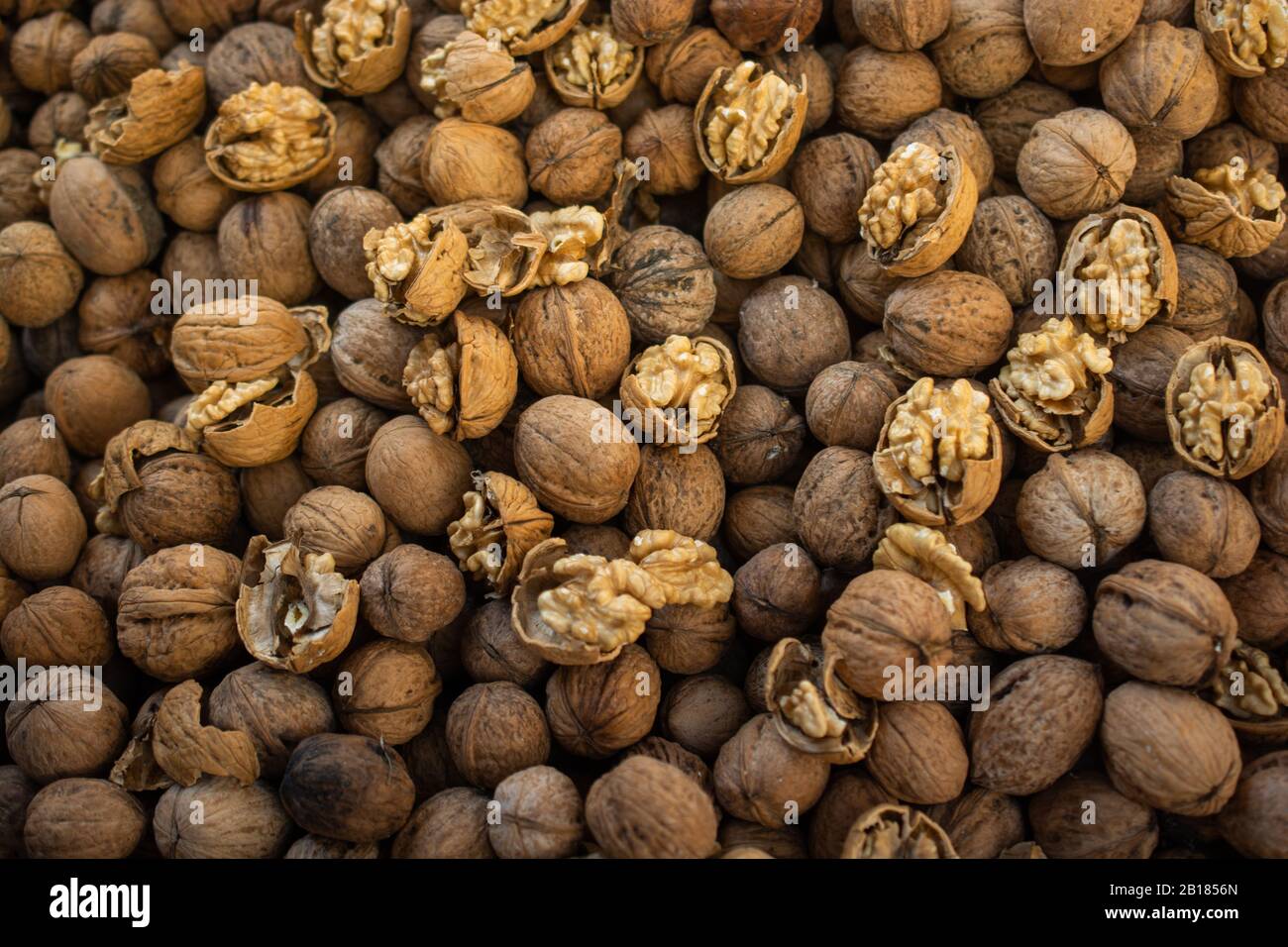 Whole walnuts background. Healthy organic food concept Stock Photo - Alamy