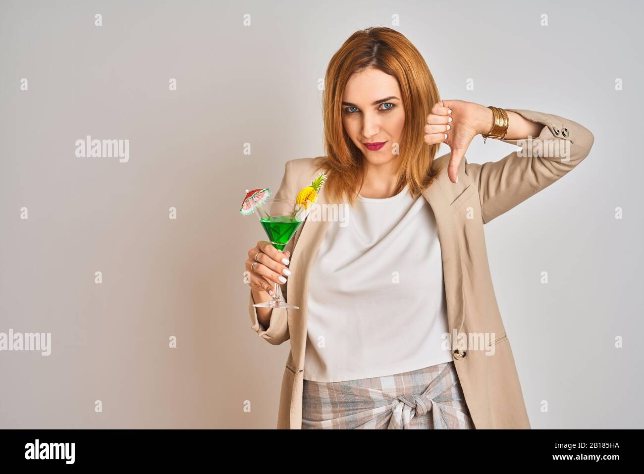 Redhead caucasian business woman drinking a summer cocktail over ...
