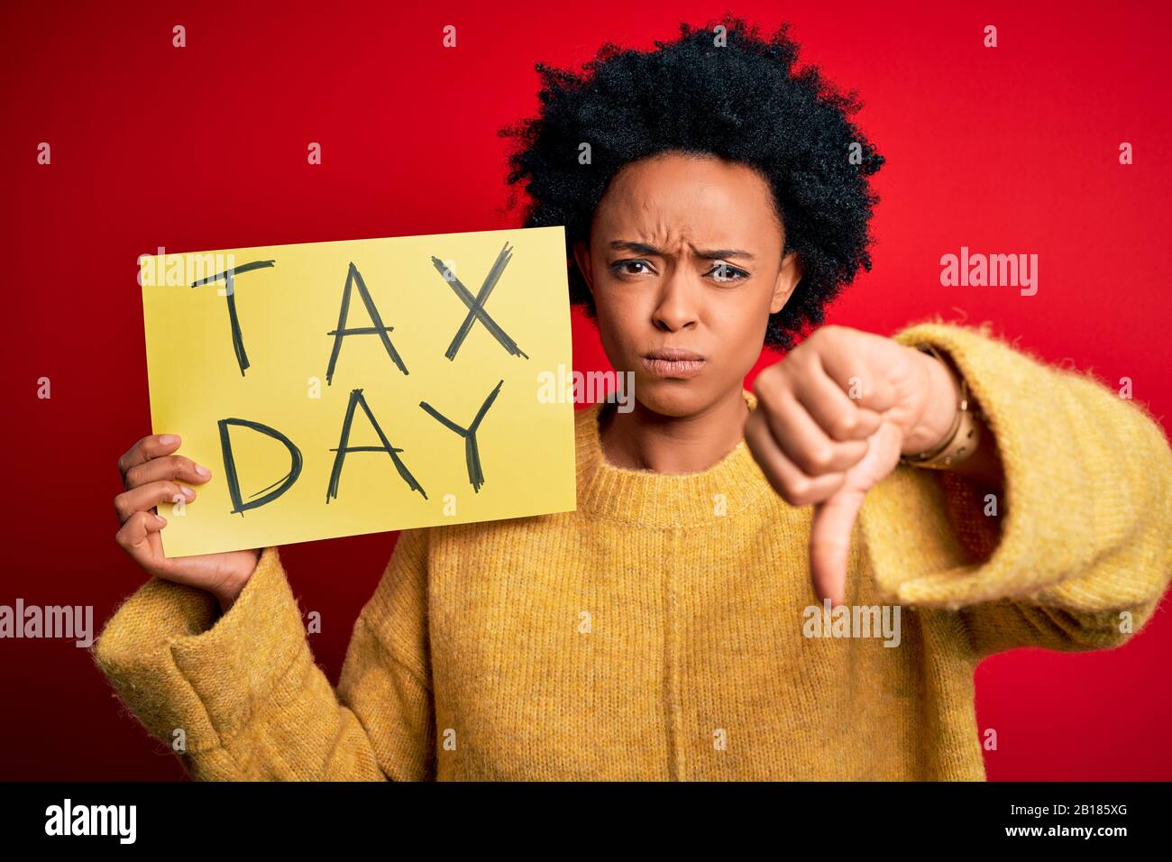 Young African American afro woman with curly hair holding paper with ...