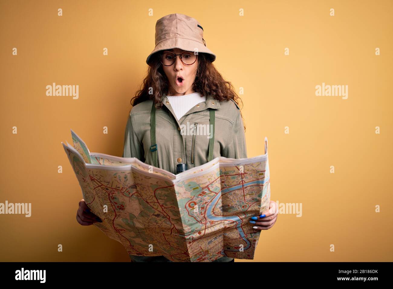 Beautiful tourist woman on vacation wearing explorer hat and water ...
