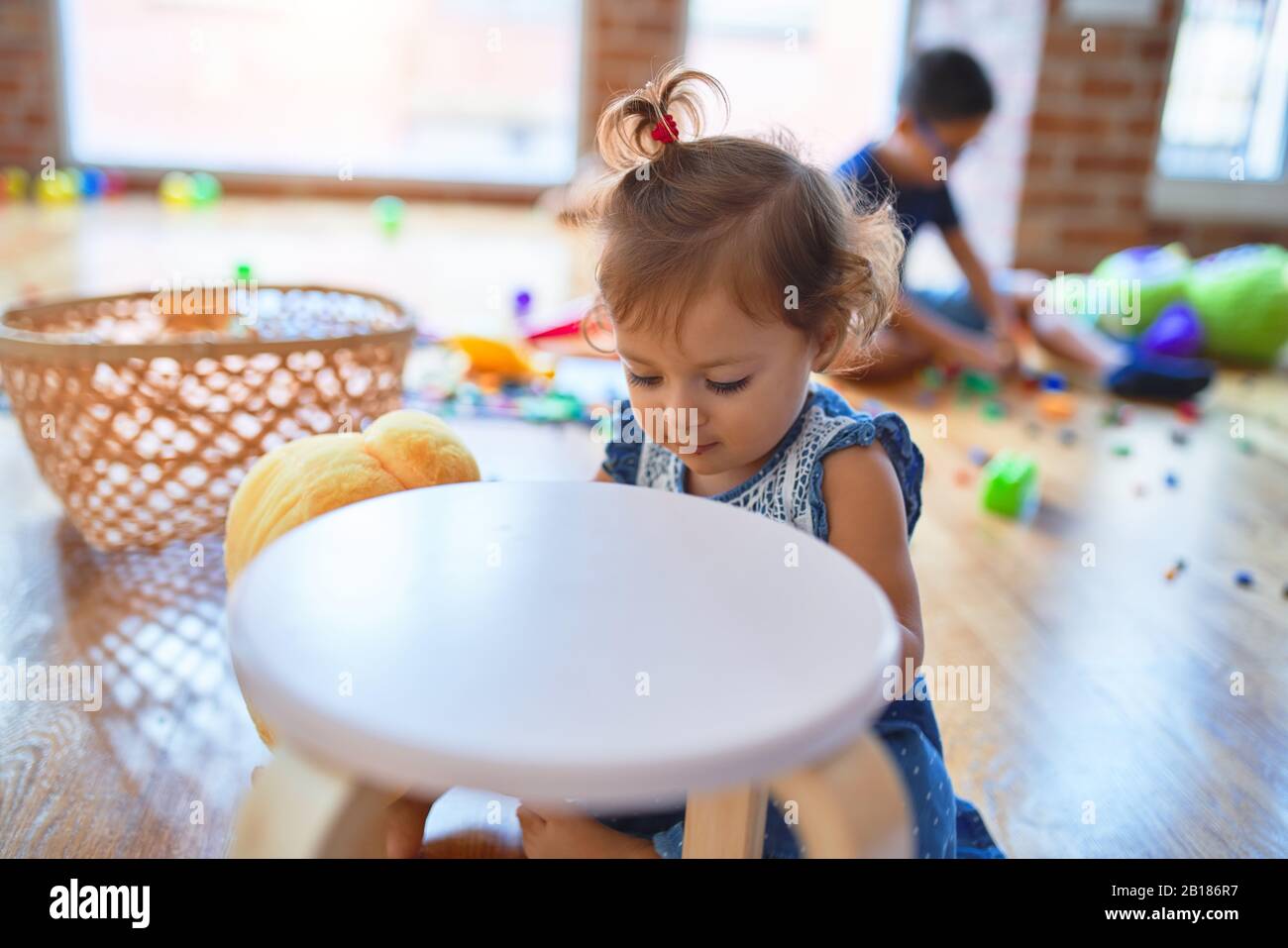 Adorable toddlers smiling happy. Sitting on the floor playing around ...
