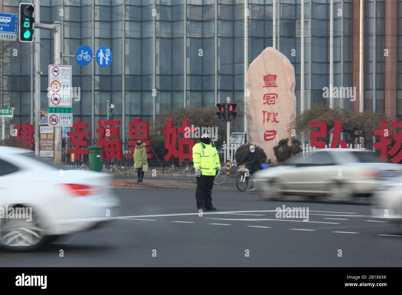 A Chinese police officer directs the traffic at a crossroad during rush ...