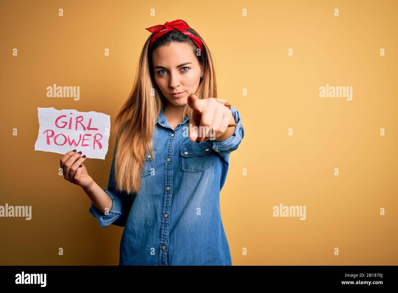 Blonde woman with blue eyes asking for girls rights holding banner with ...