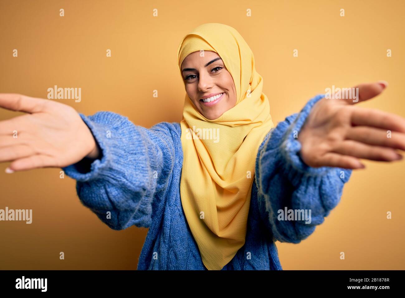 Young beautiful brunette muslim woman wearing arab hijab over isolated ...