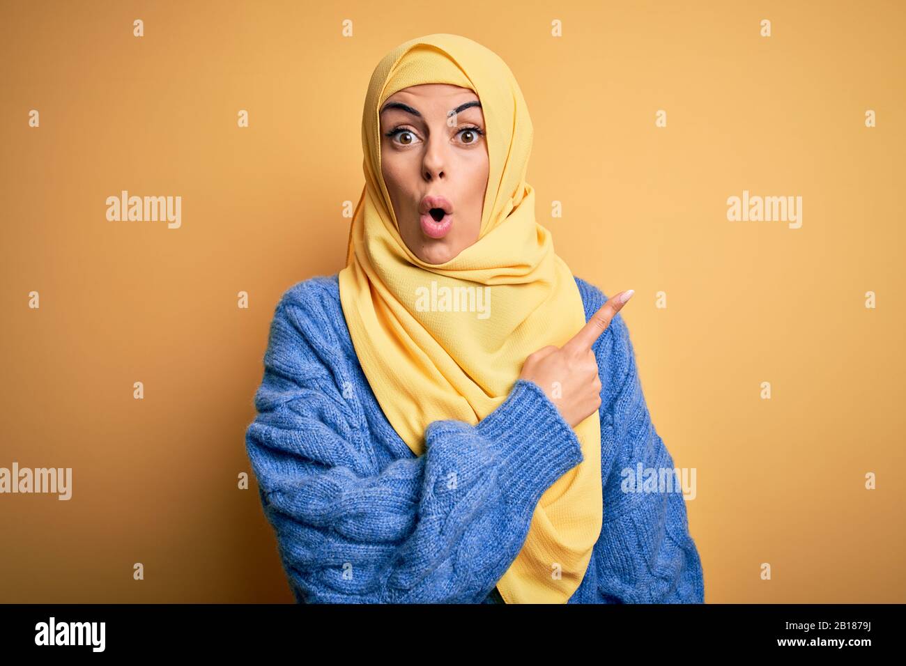 Young beautiful brunette muslim woman wearing arab hijab over isolated ...
