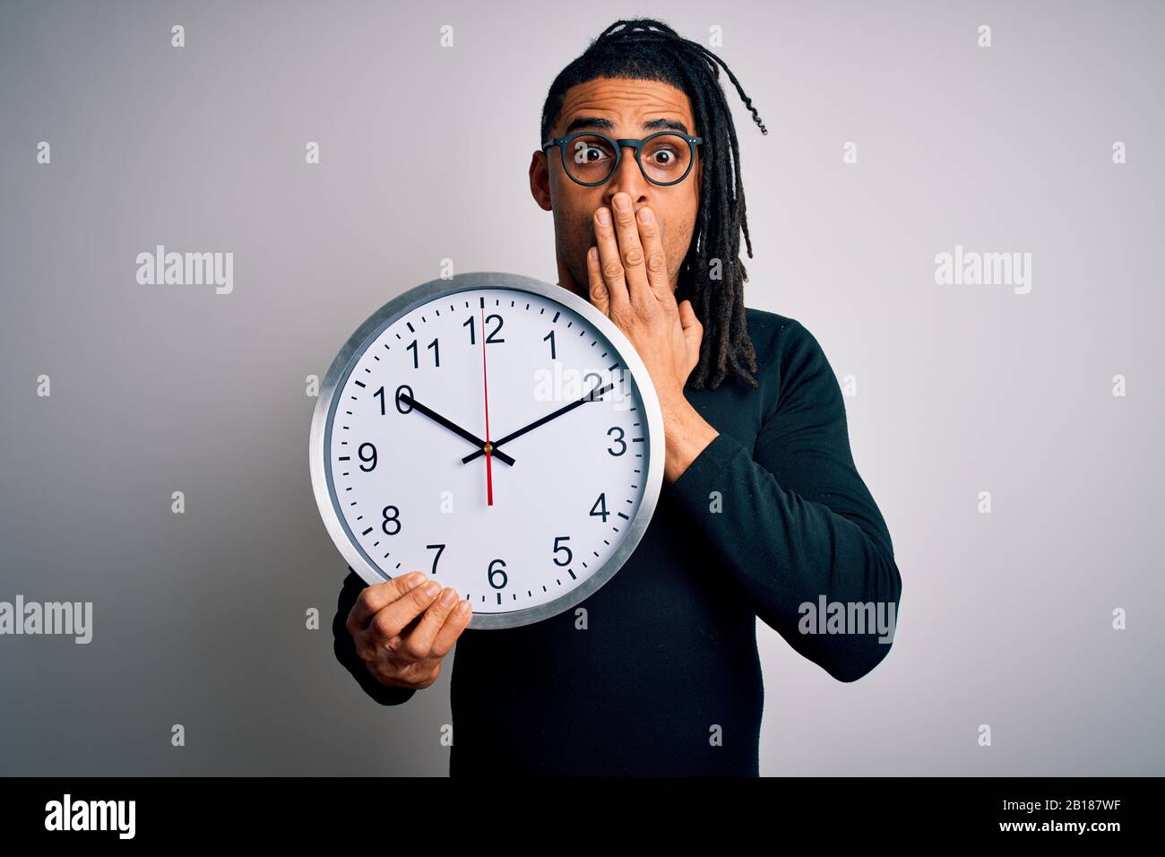 Young african american afro man doing countdown holding bic clock over ...