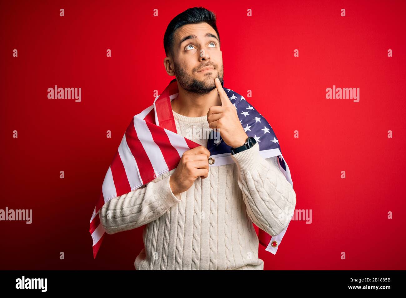 Young handsome patriotic man wearing united states flag celebrating ...