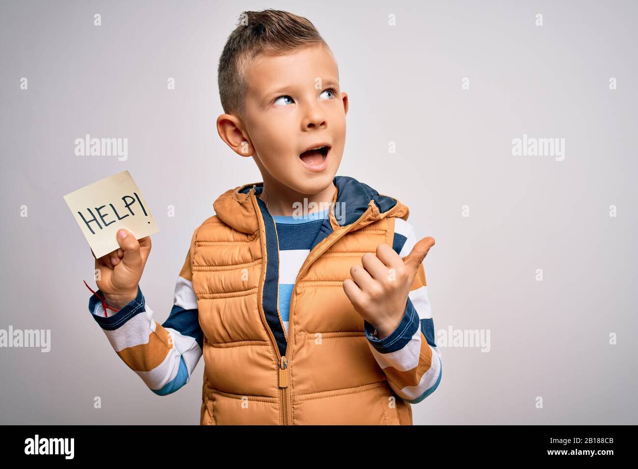 Young little caucasian kid asking for help on a paper note as violence ...
