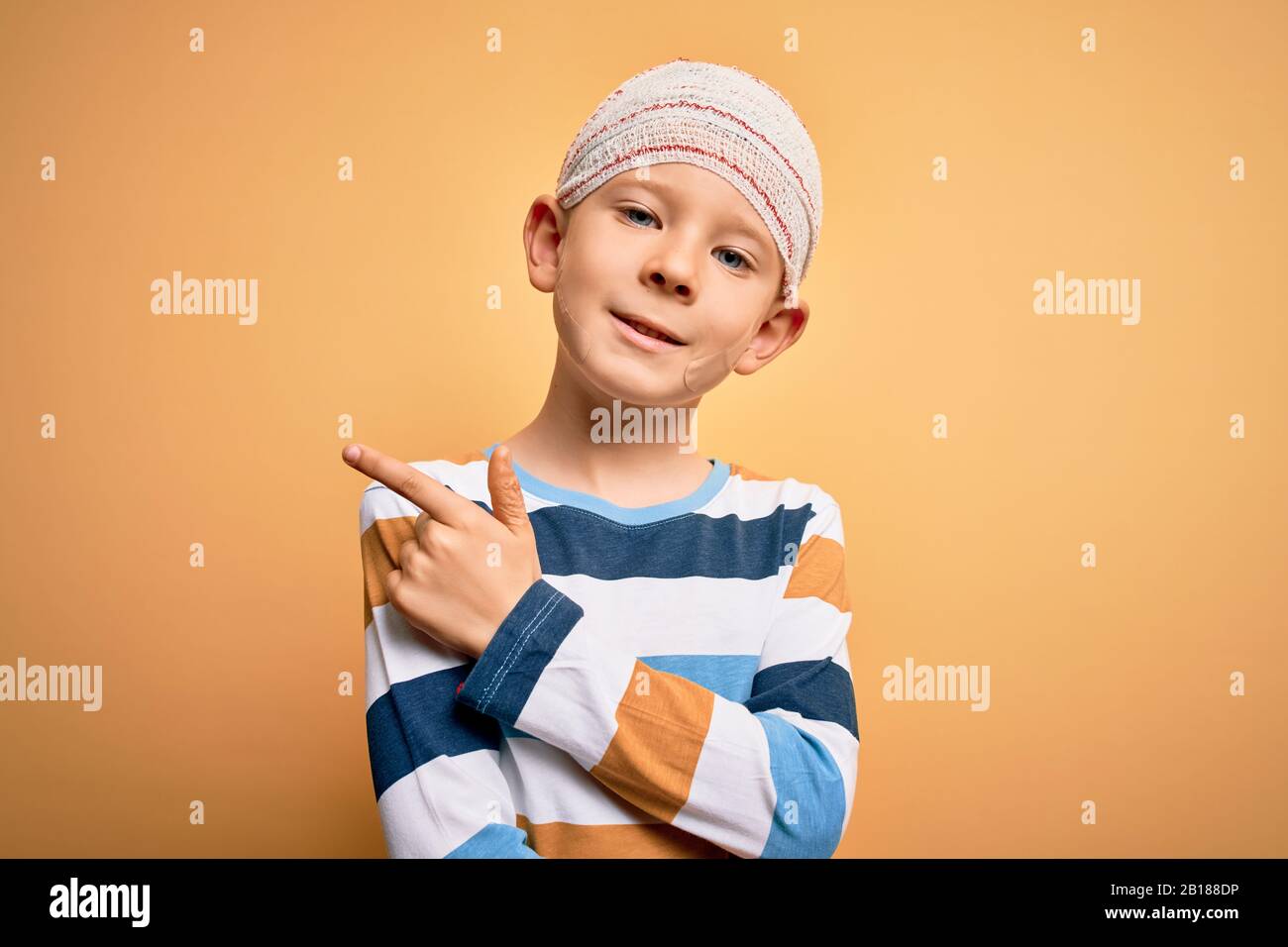 Young little caucasian kid injured wearing medical bandage on head over ...