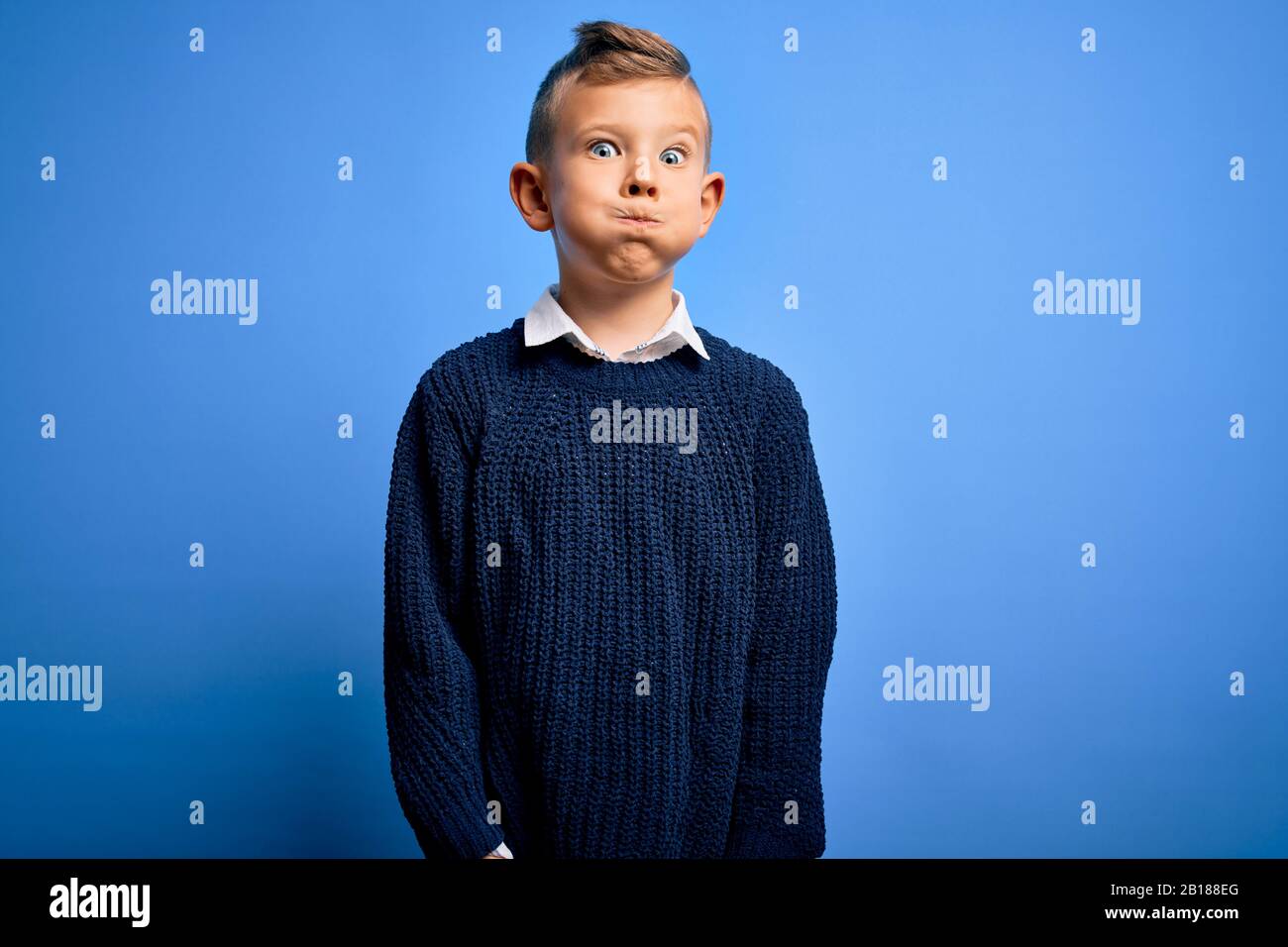 Young little caucasian kid with blue eyes wearing winter sweater over ...