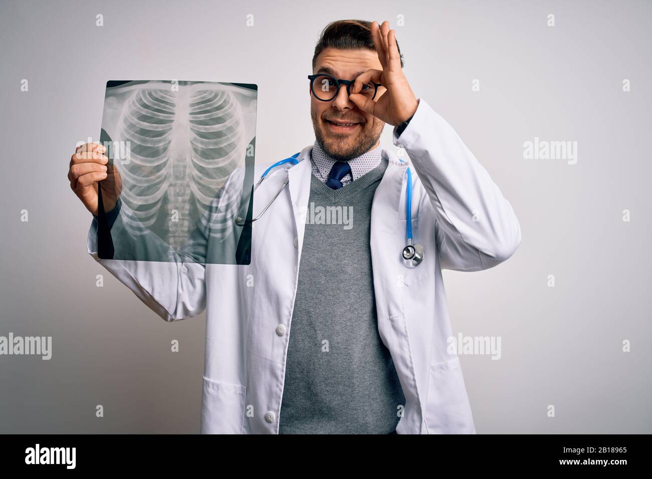Young doctor man wearing medical coat looking at chest scan radiography ...