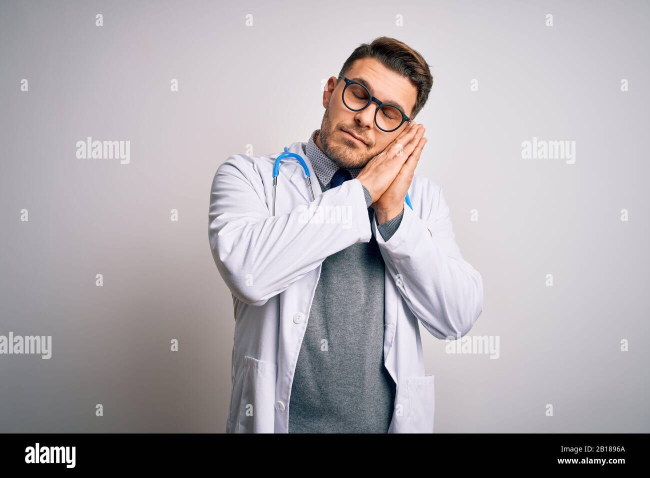 Young doctor man with blue eyes wearing medical coat and stethoscope ...