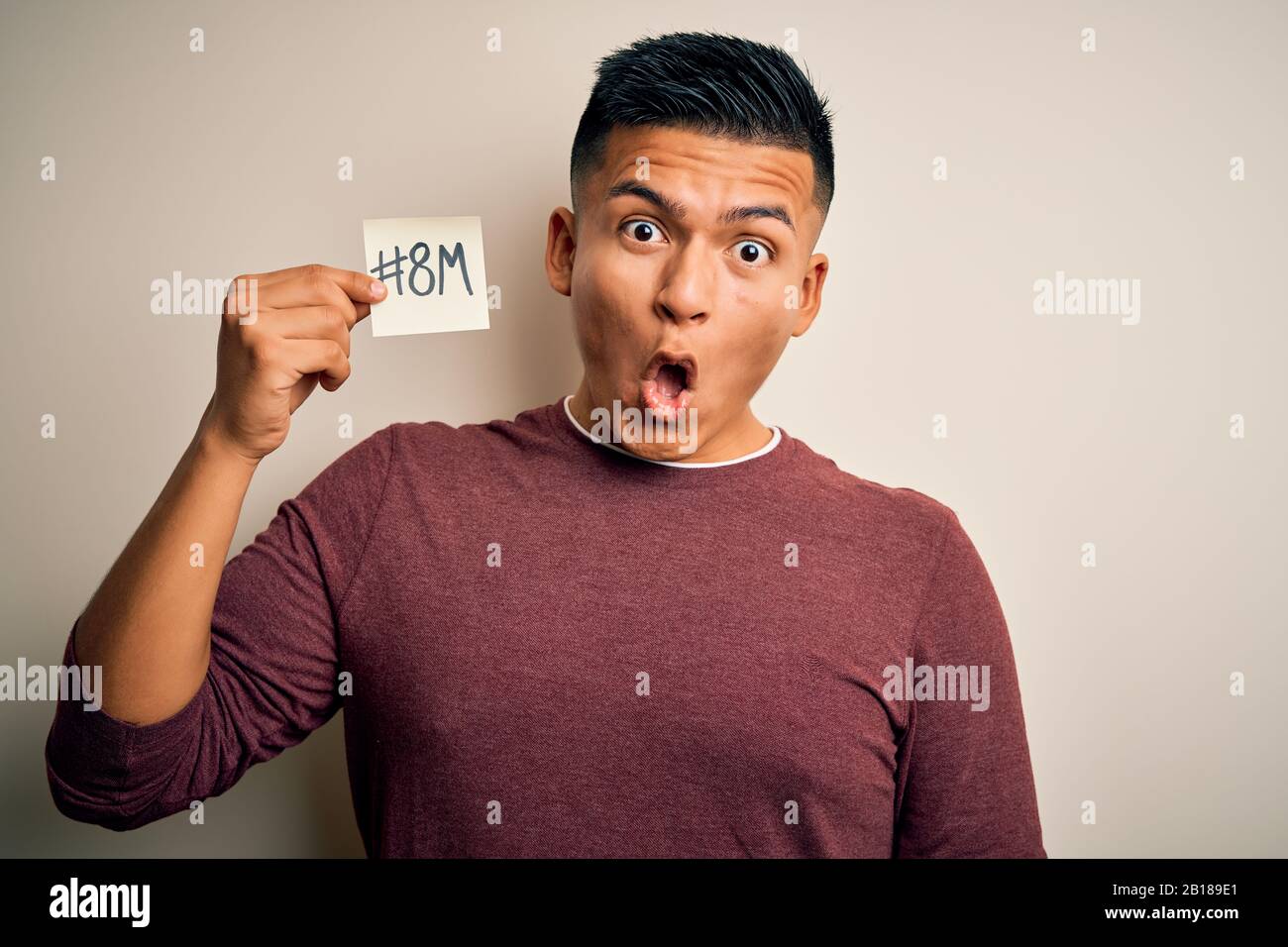 Young handsome latin man celebrating 8th march womens day holding ...