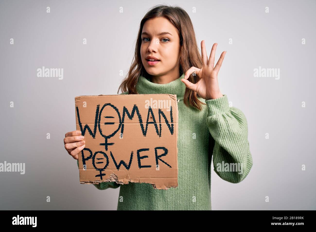 Young blonde girl holding protest banner for woman power and rights ...