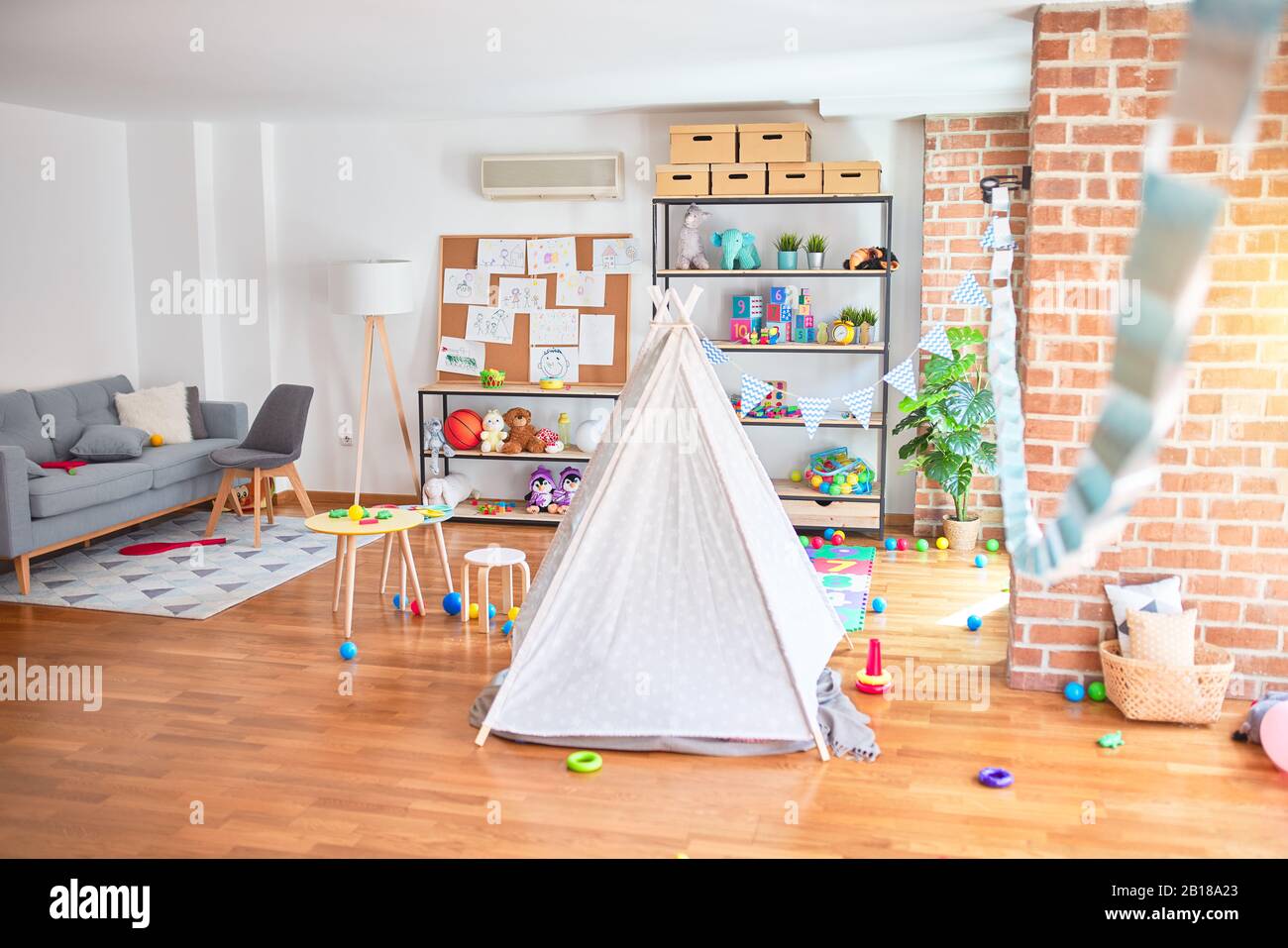 Picture of preschool playroom with colorful furniture, and toys around ...