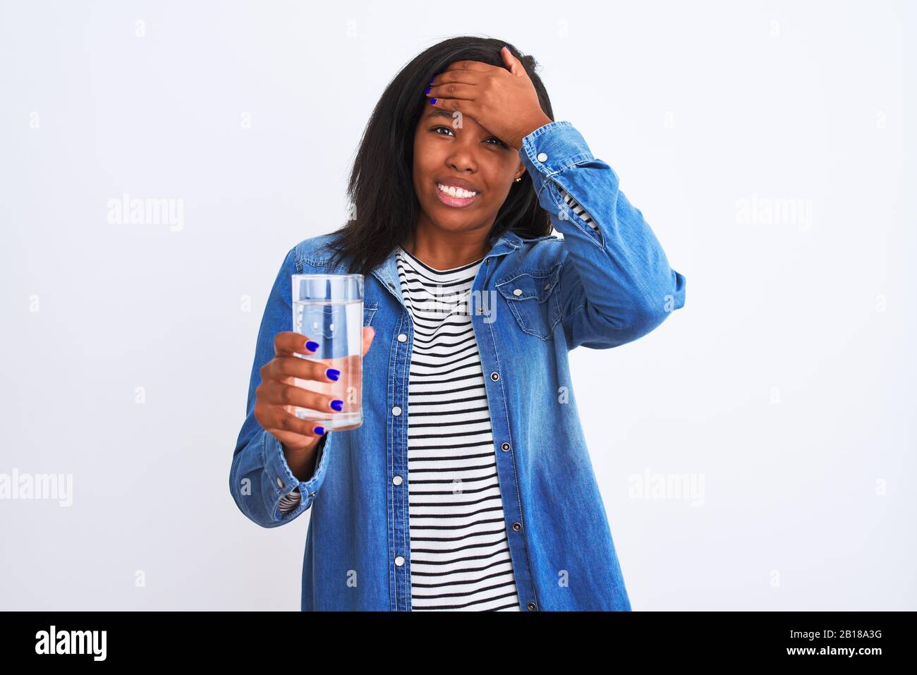 Young african american woman drinking a glass of fresh water over ...