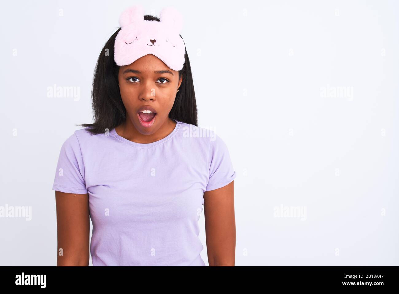 Young african american woman wearing sleeping mask over isolated ...