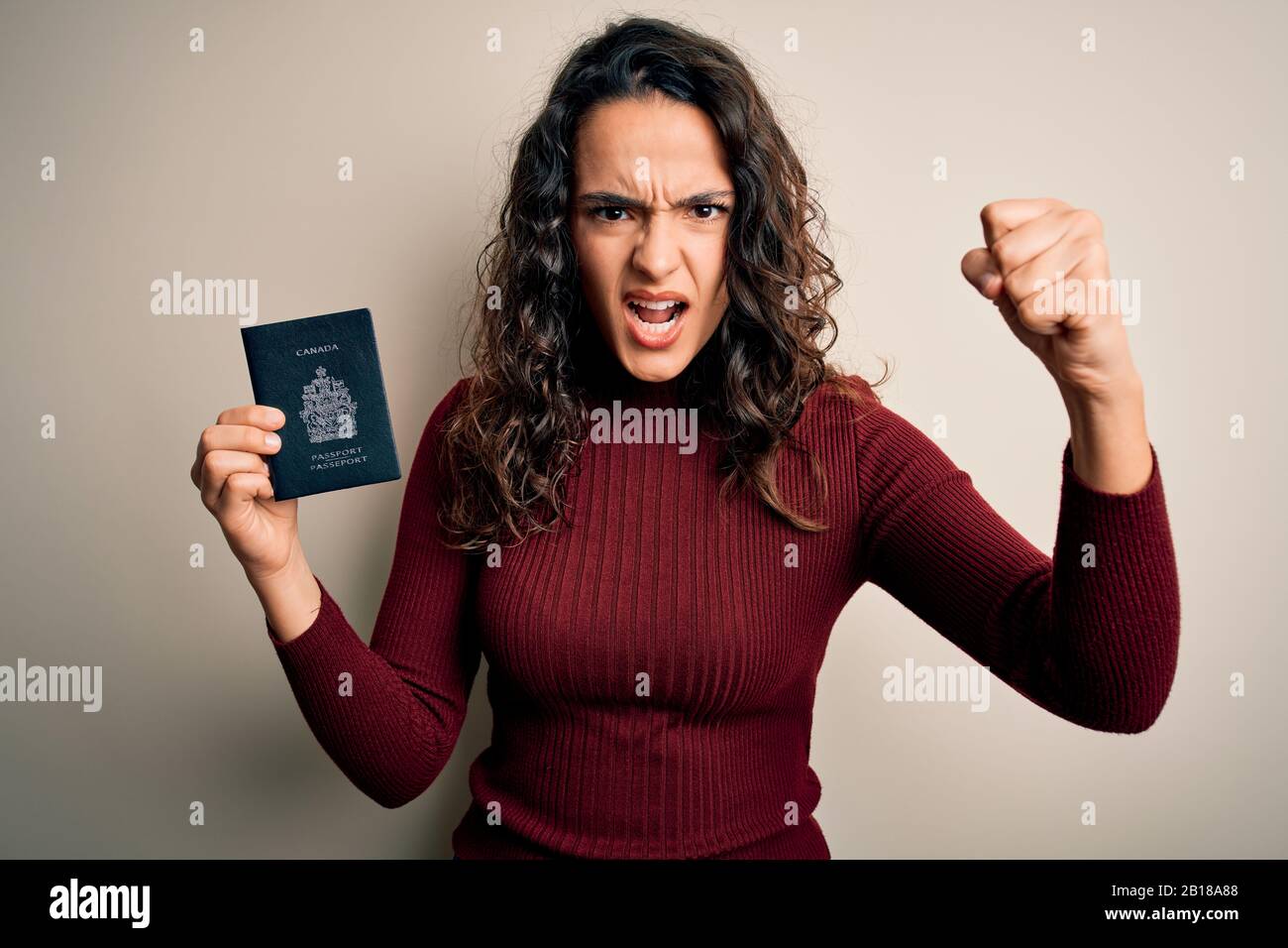 Young beautiful tourist woman with curly hair on vacation holding ...