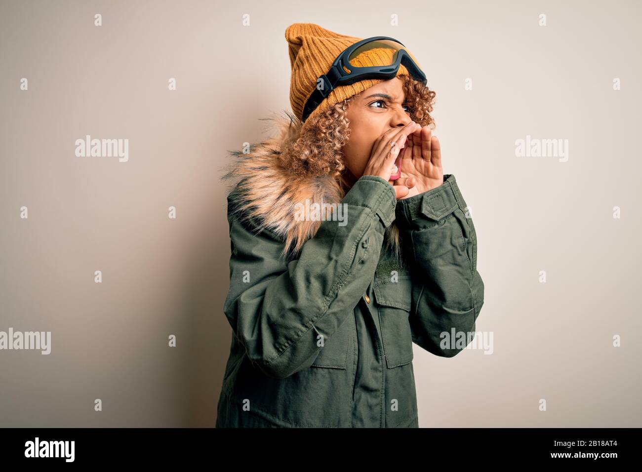 Young african american skier woman with curly hair wearing snow ...