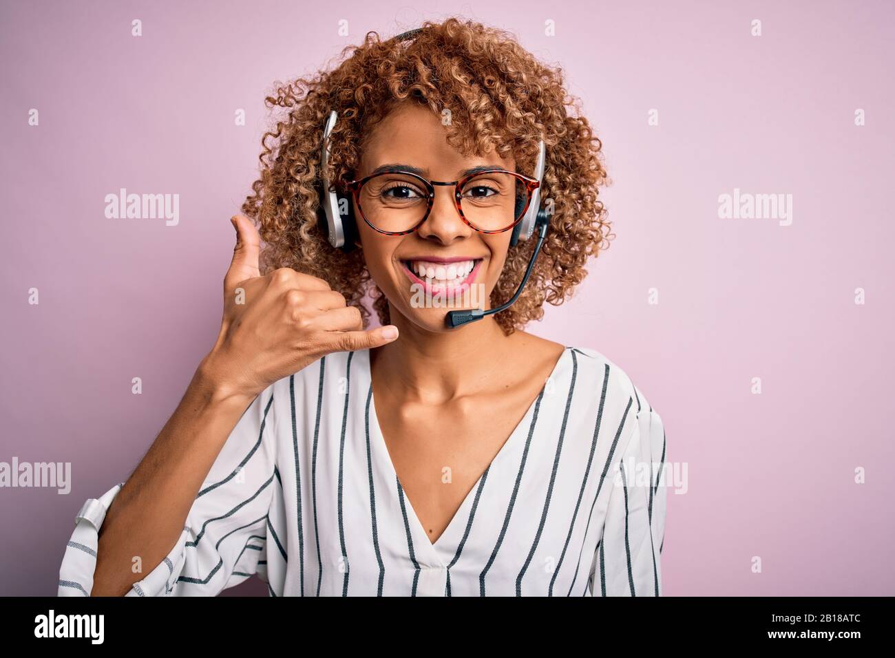 African american curly call center agent woman working using headset ...