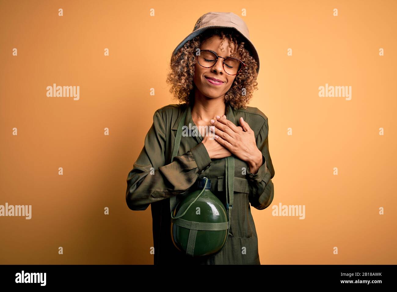 Young african american tourist woman on vacation wearing explorer hat ...